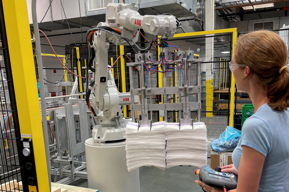 FILE PHOTO: A researcher works on a new robot for handling sheets in ...
